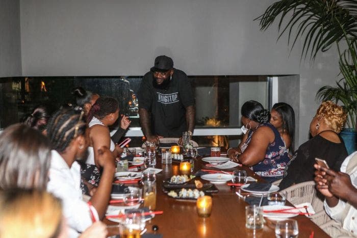 Rick Ross celebrates another sales milestone with Wingstop staff